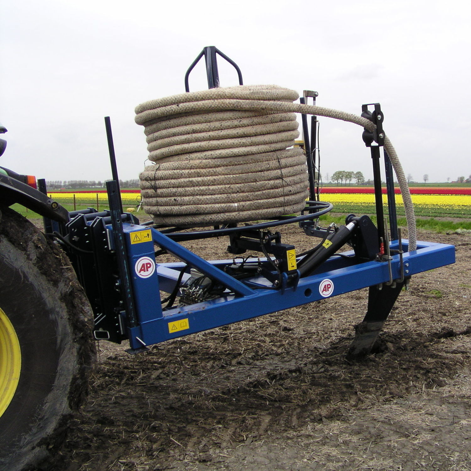 Tractor-mounted drainage plow - AP Machinebouw B.V. - with hose reel